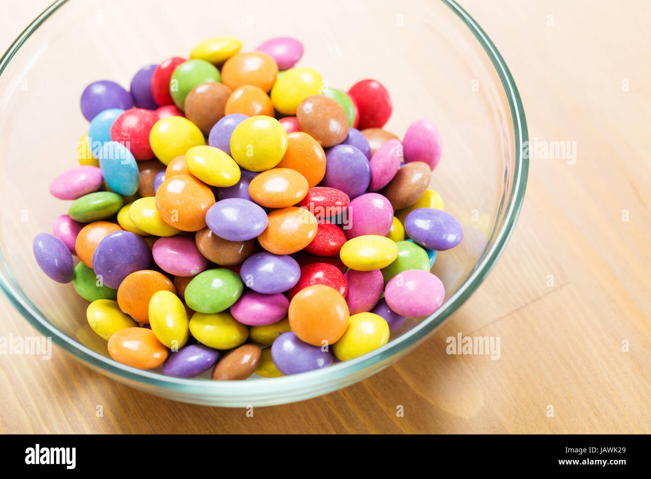 Colourful candy in bowl Stock Photo - Alamy