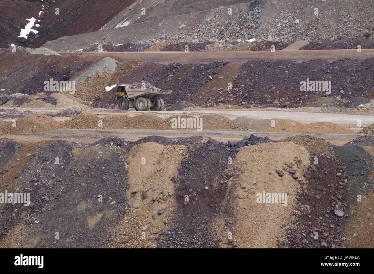 Large mining truck carrying ore across an open pit mine Stock Photo - Alamy