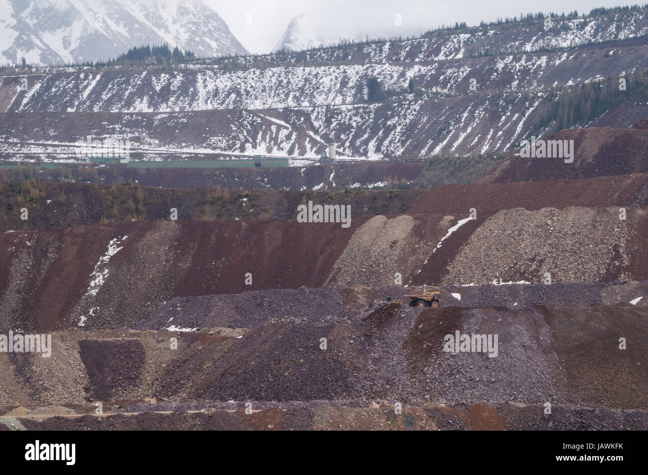 Large mining truck carrying ore across an open pit mine Stock Photo - Alamy