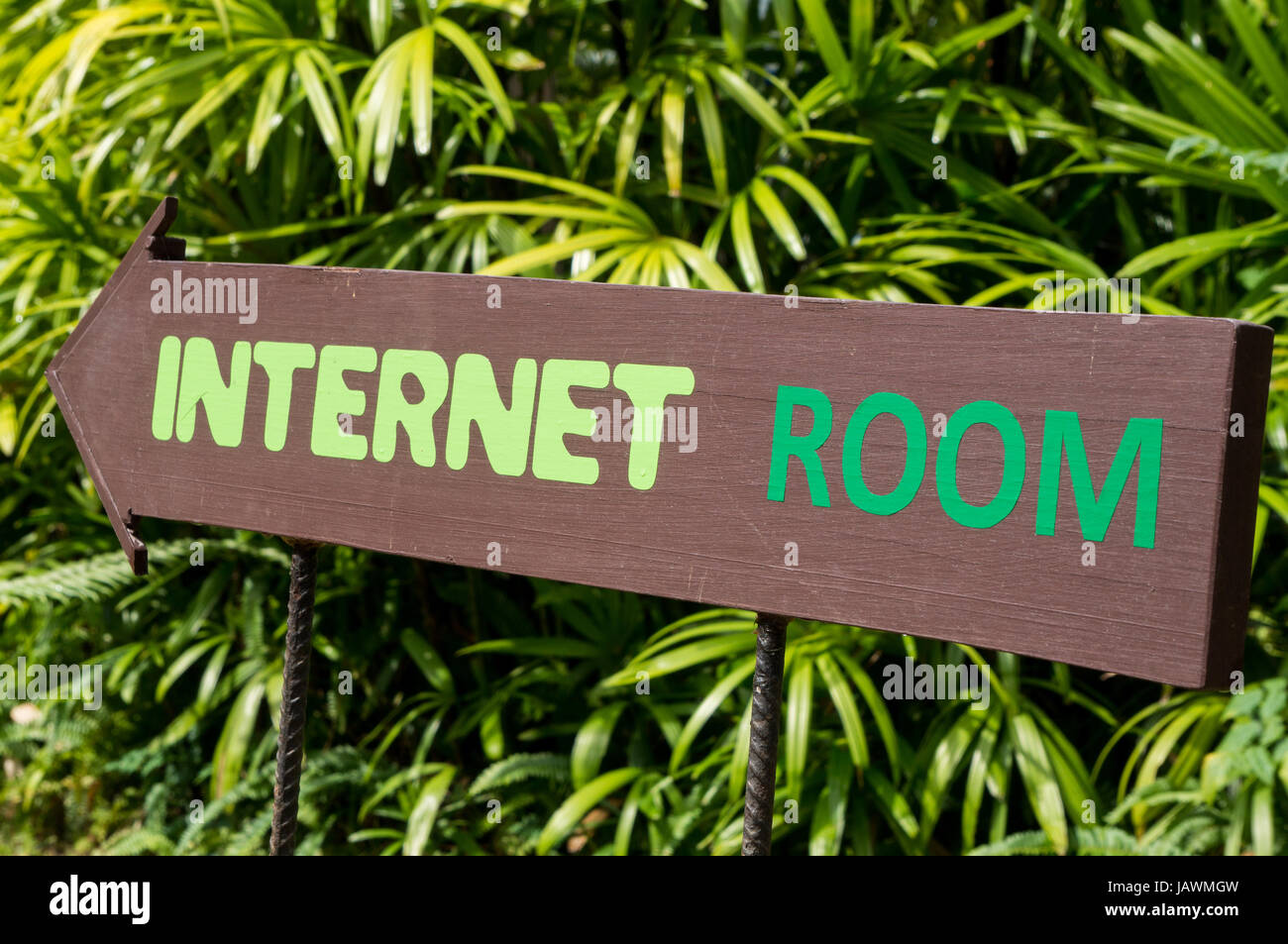 "Internet Room" arrow sign with tropical vegetation Stock Photo - Alamy