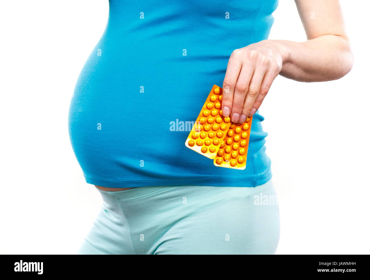 Pregnant woman holding medical pills, tablets or supplements, vitamin ...