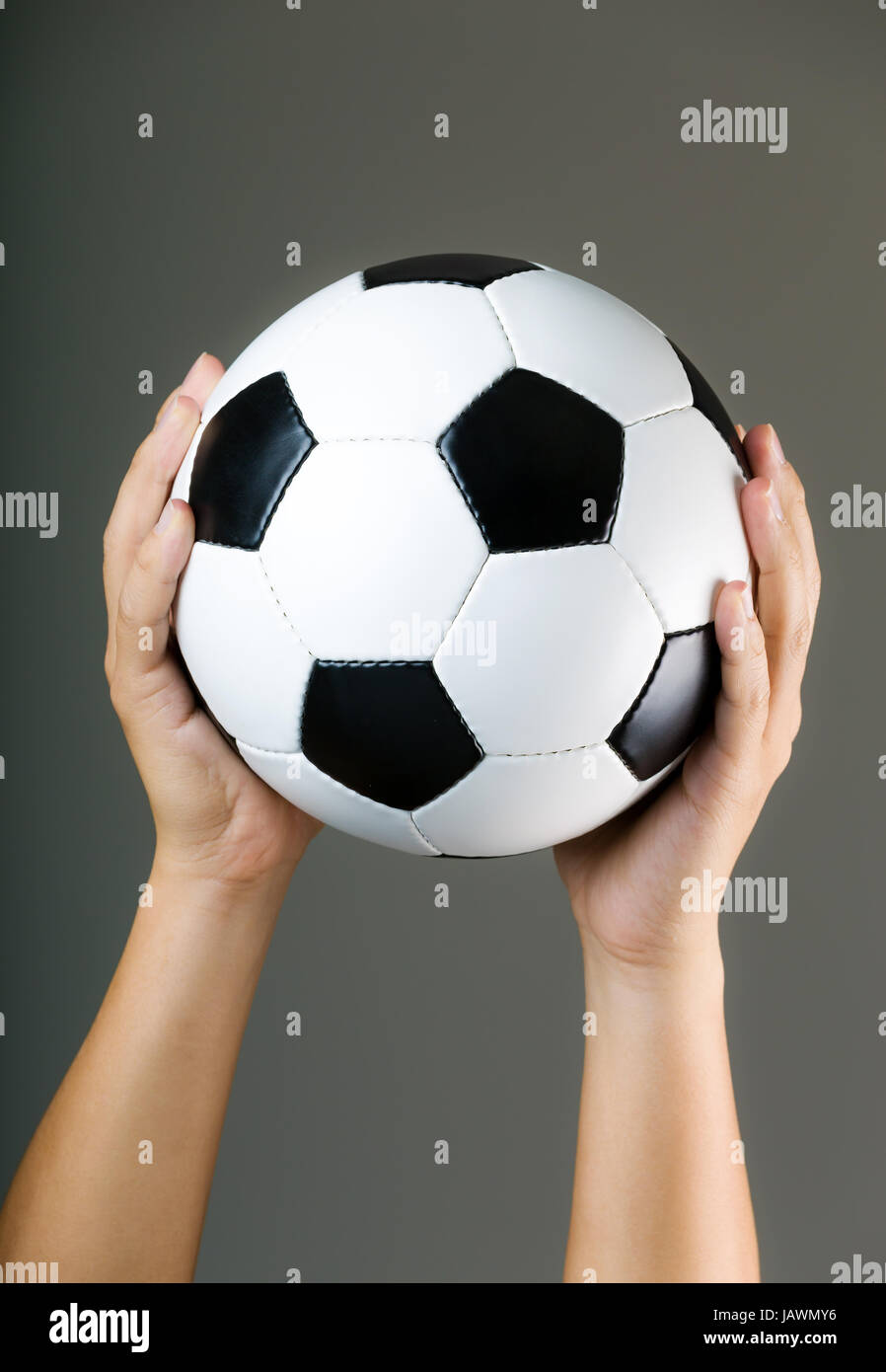 Hand holding soccer ball Stock Photo - Alamy