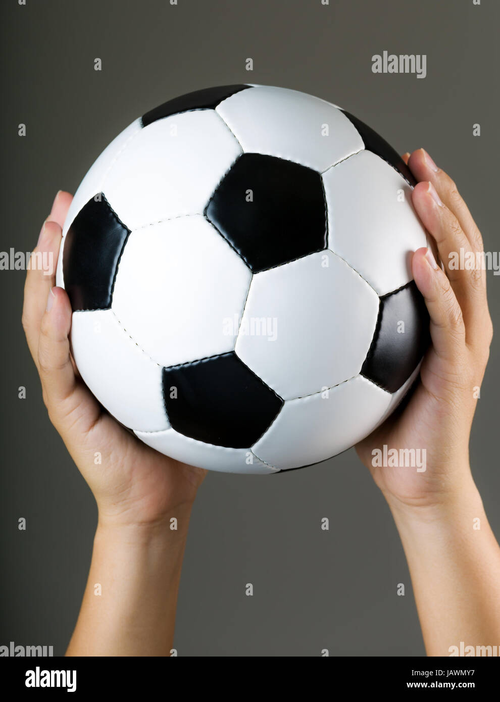 Hand holding soccer ball Stock Photo - Alamy