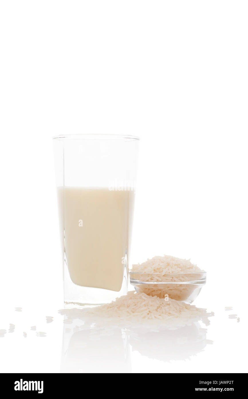 Rice milk in glass raw rice crop in bowl isolated on white background ...