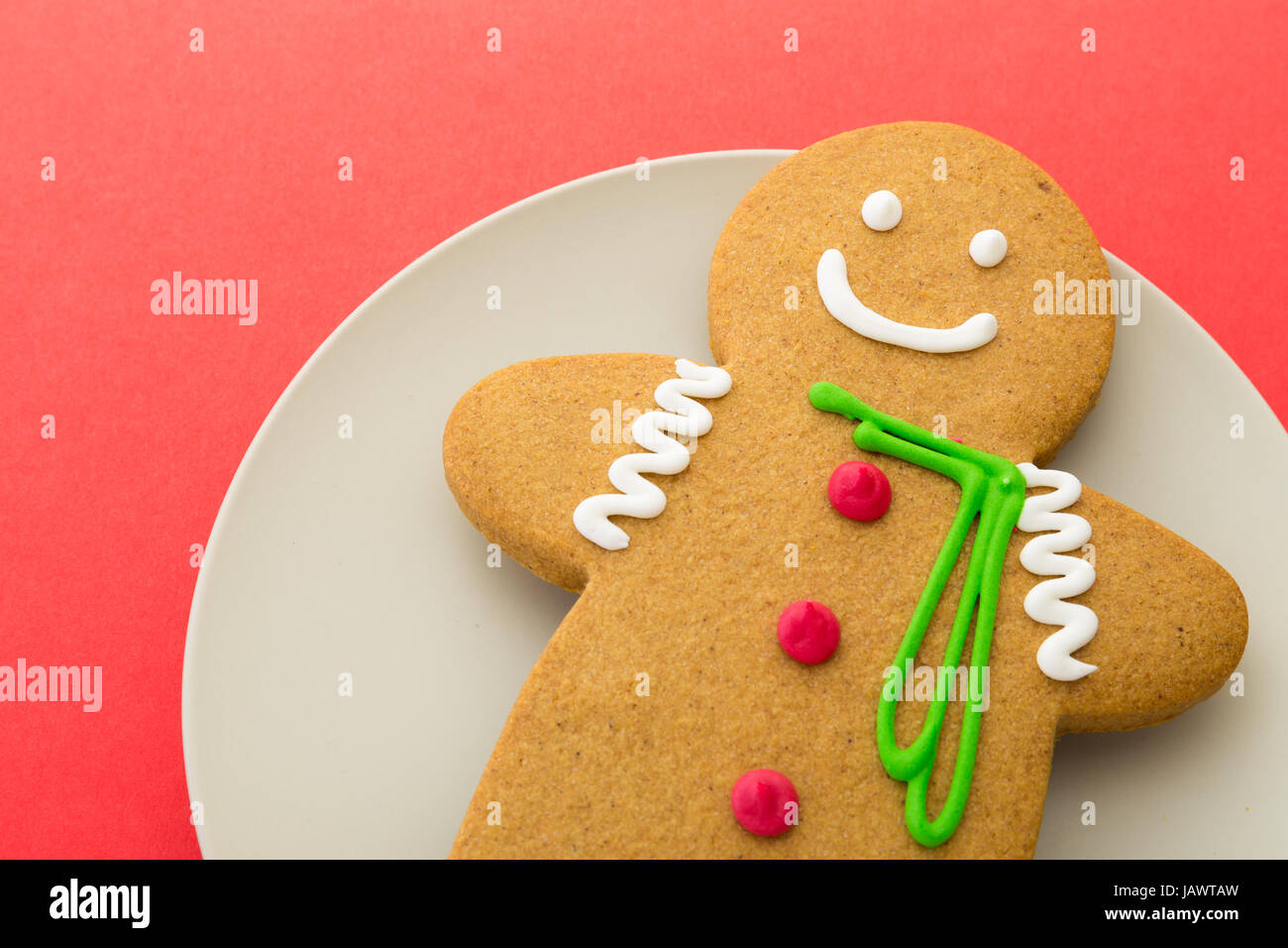 Gingerbread man on red background Stock Photo - Alamy