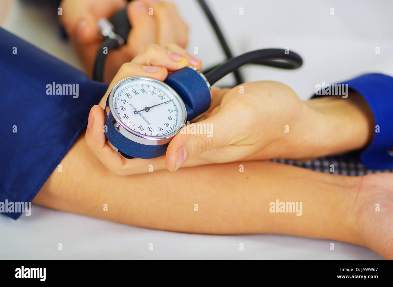 Close up of a young doctor using the stethoscope to hear the pulse ...