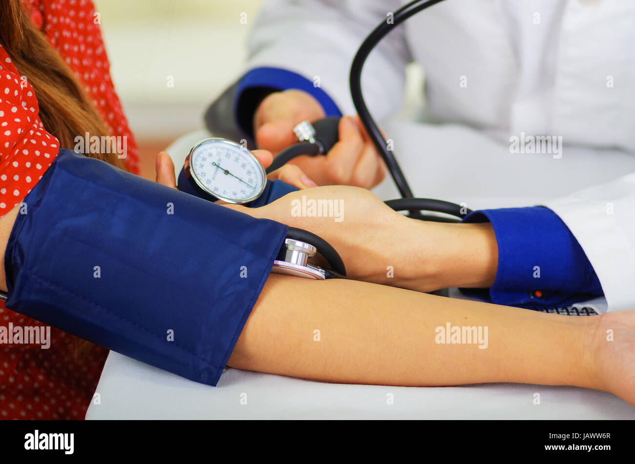 Close up of a young doctor using the stethoscope to hear the pulse ...