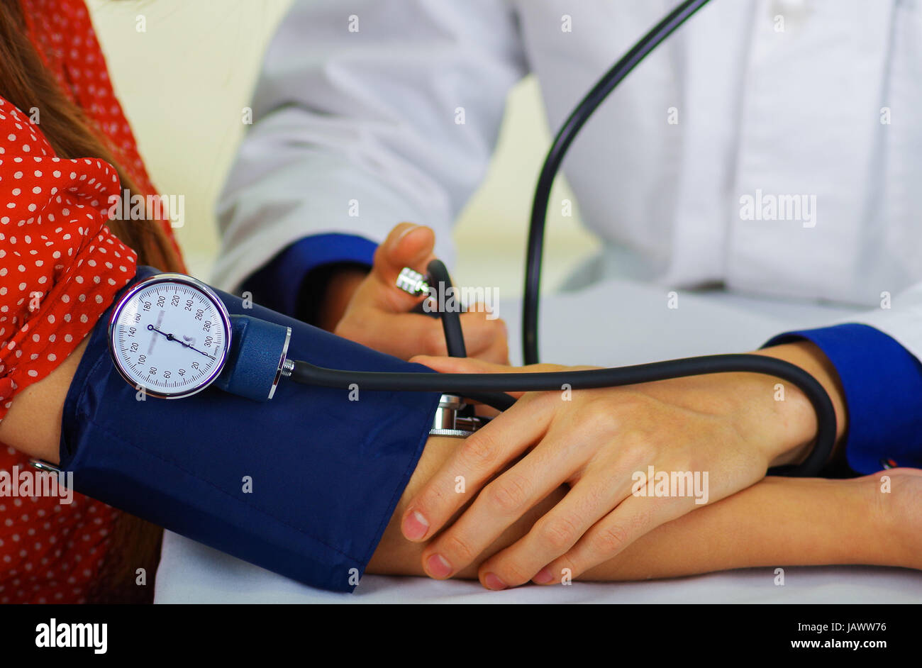 Close up of a young doctor using the stethoscope to hear the pulse ...