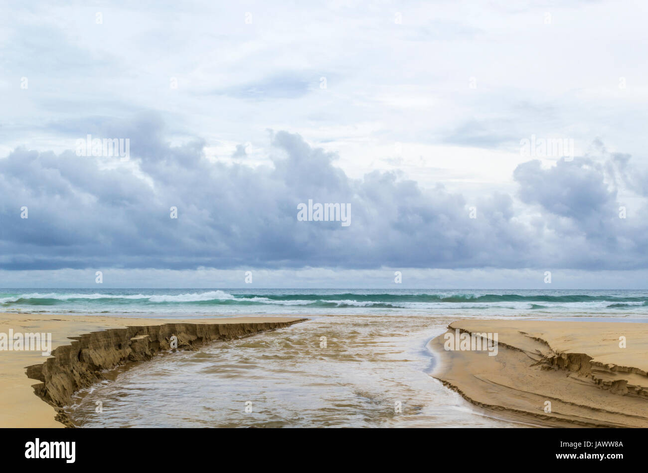 Nimbus over sea and watercourse in the beach Stock Photo - Alamy