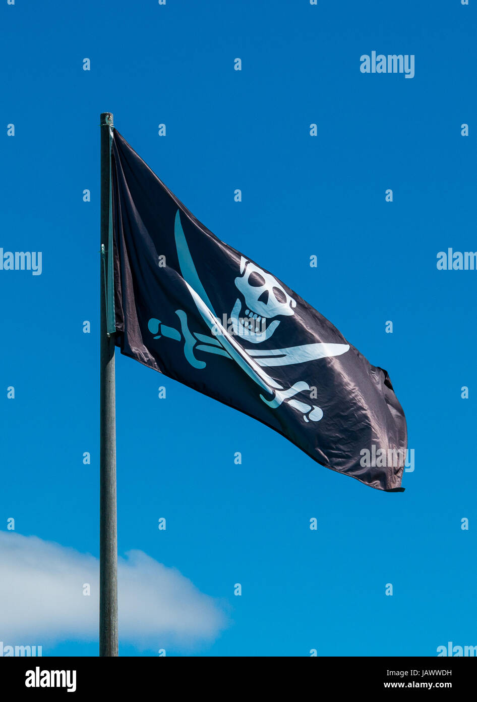 Black pirate flag flying high in the blue sky Stock Photo - Alamy