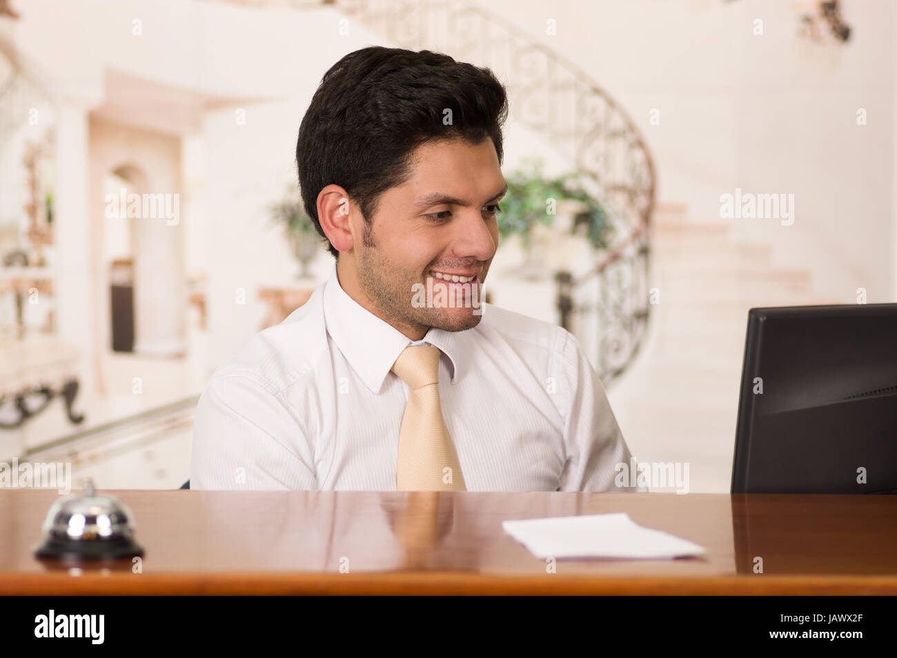 Happy smiling receptionist in hotel looking friendly for the guests in ...