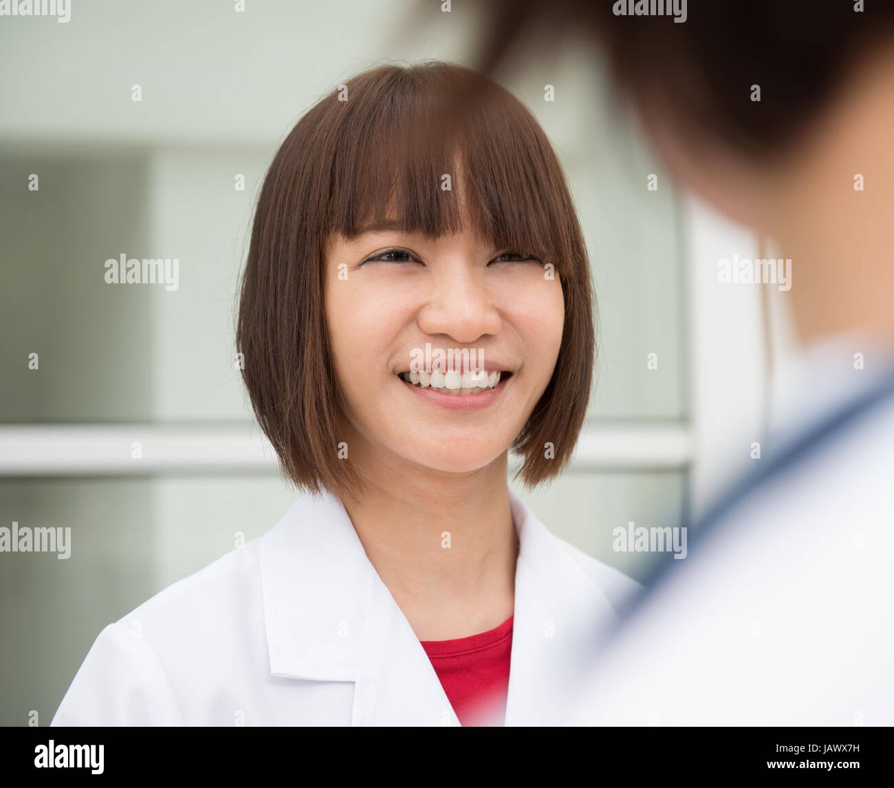 Asian medical doctors having discussion at hospital corridor Stock ...