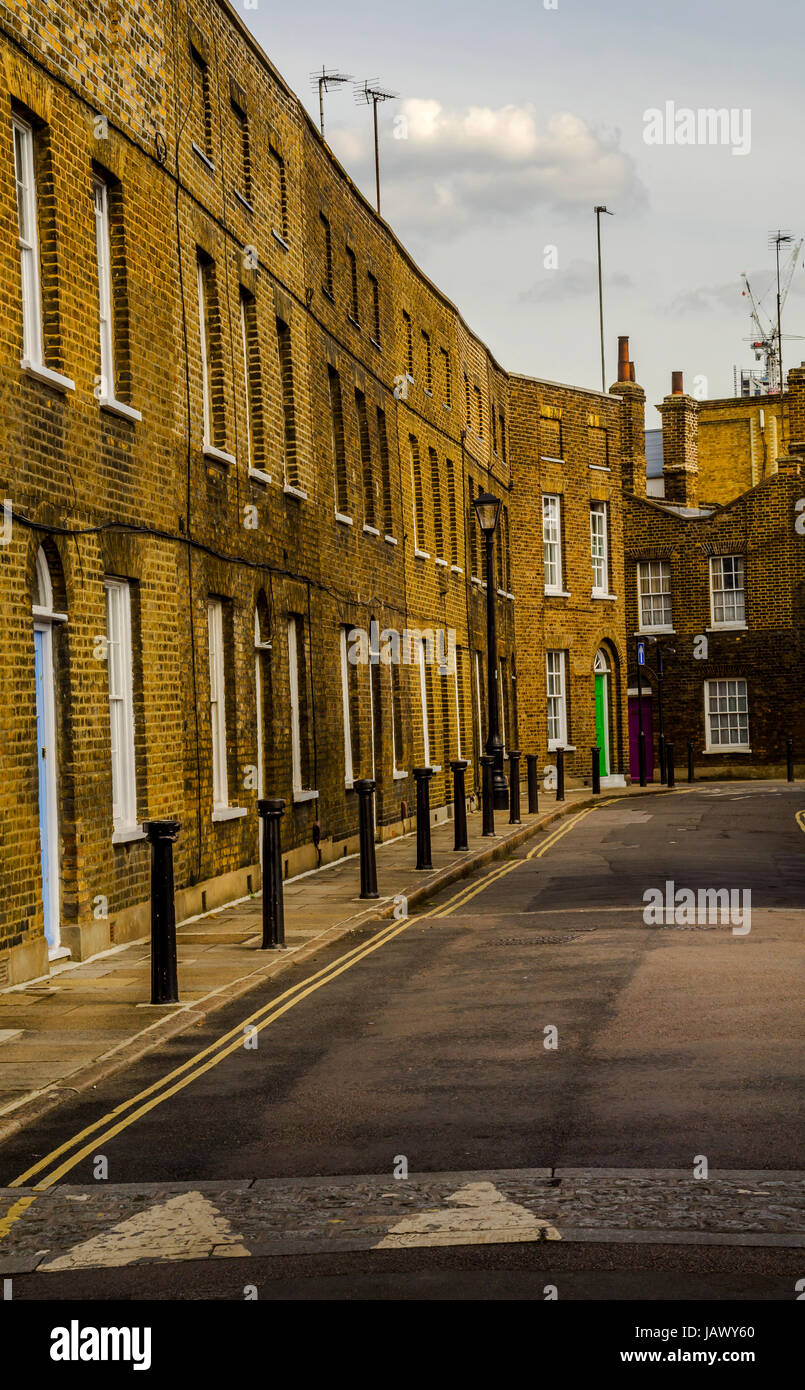 Typical old English buildings, low brick buildings across a narrow ...