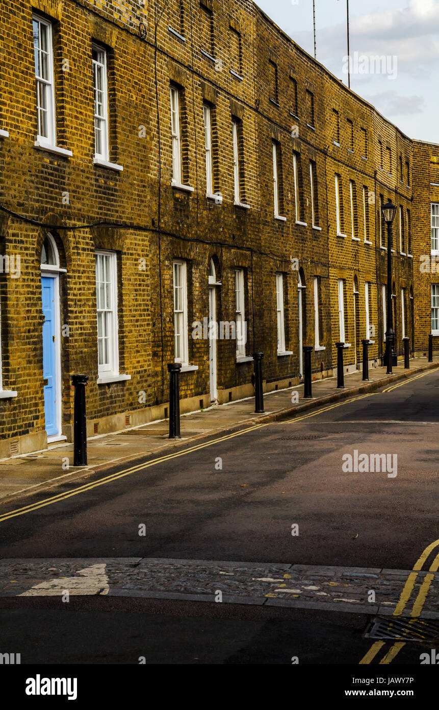Typical old English buildings, low brick buildings across a narrow ...