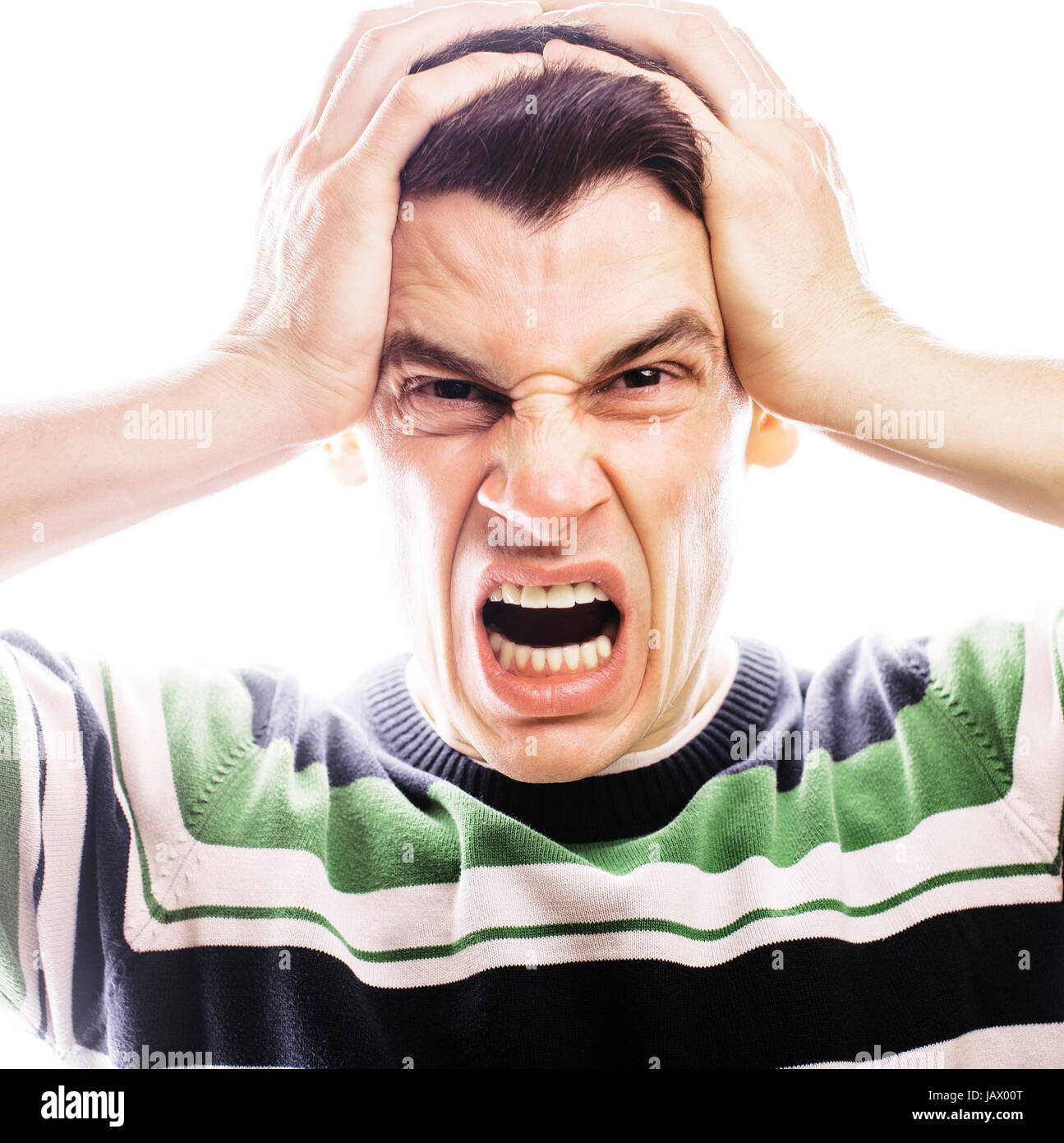 Portrait of a smart serious young man standing against white bac Stock ...
