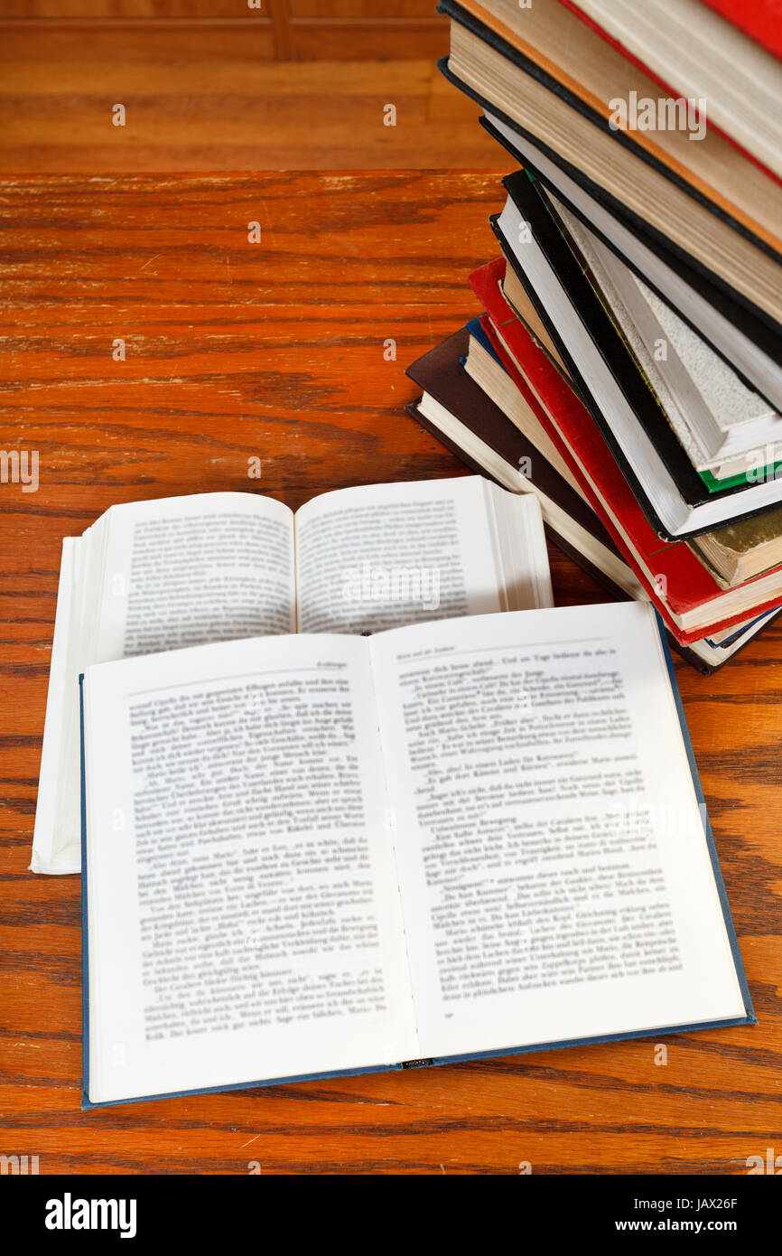 two open books with blur font on wooden table Stock Photo - Alamy