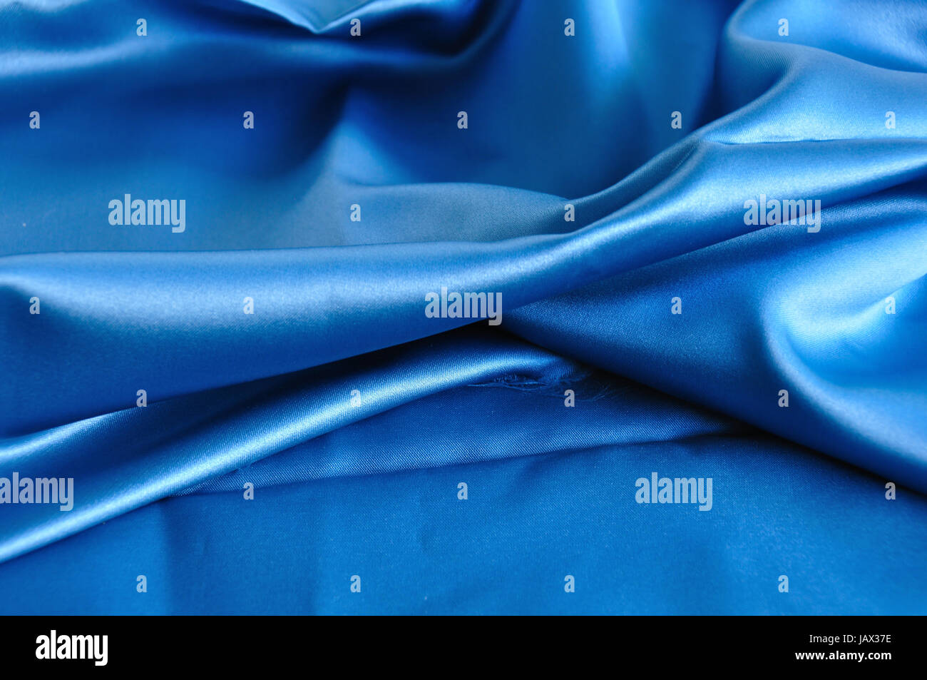 Blue fabric texture. Folded silk textile abstract background Stock Photo - Alamy