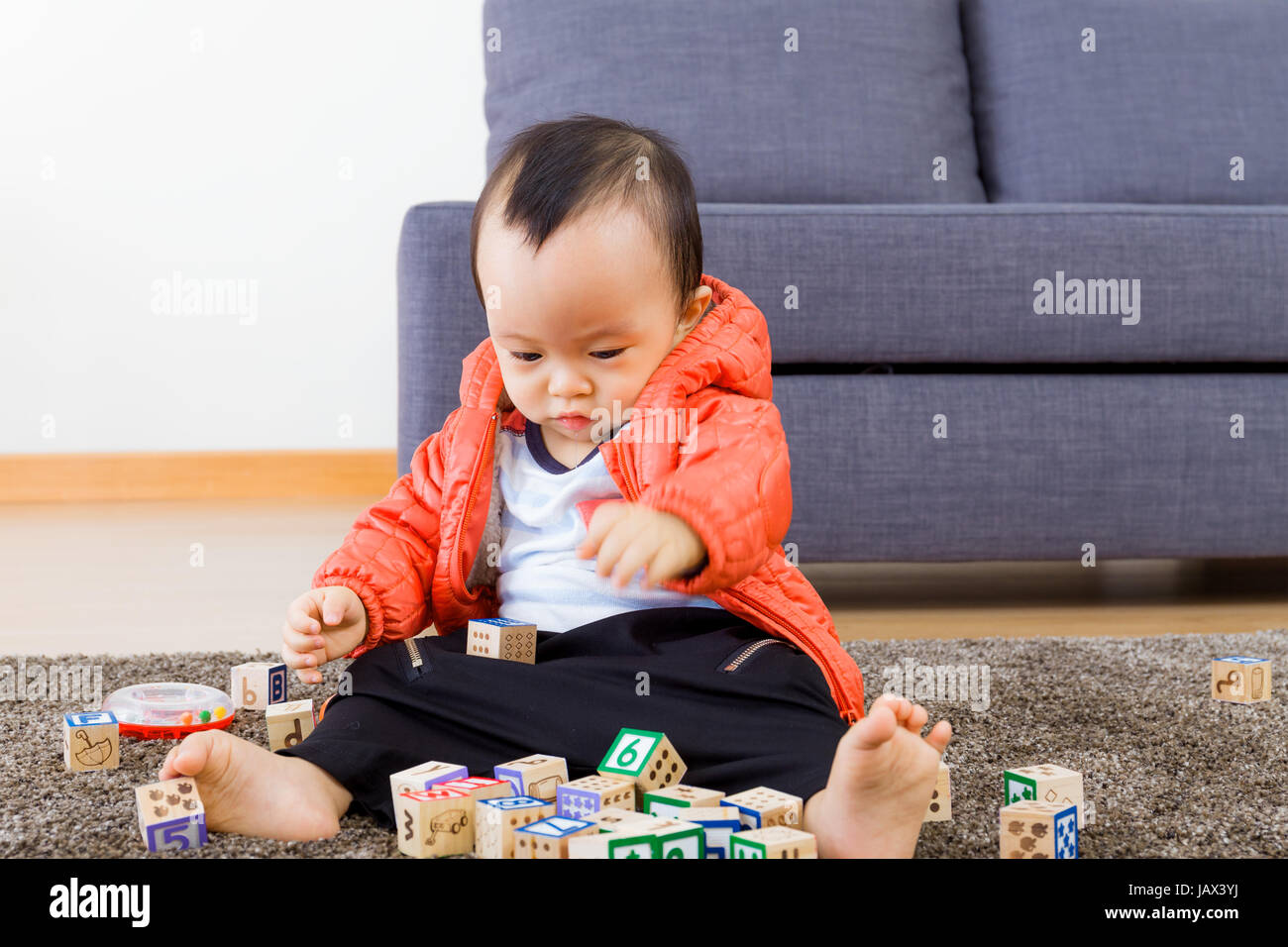 Asian baby playing wooden block at home Stock Photo - Alamy