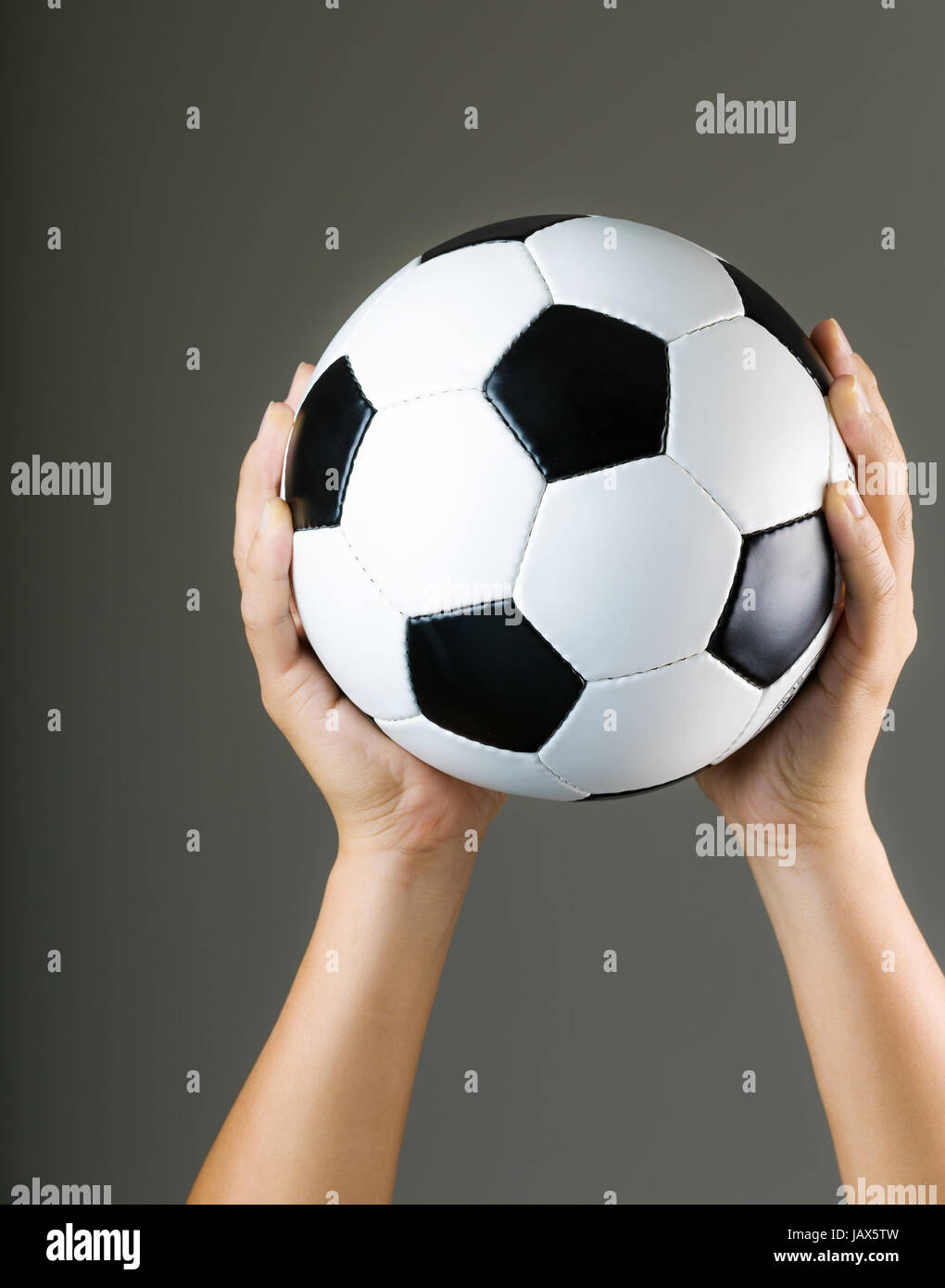 Hands holding soccer ball Stock Photo - Alamy