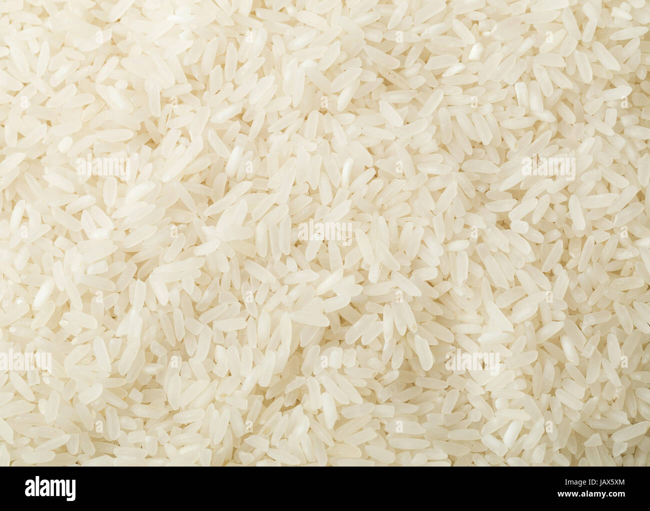 Uncooked white rice background Stock Photo - Alamy