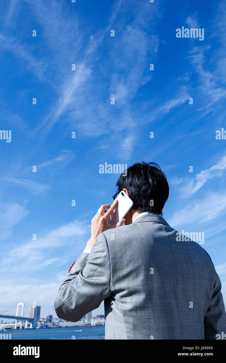 Japanese businessman on the phone downtown Tokyo, Japan Stock Photo - Alamy