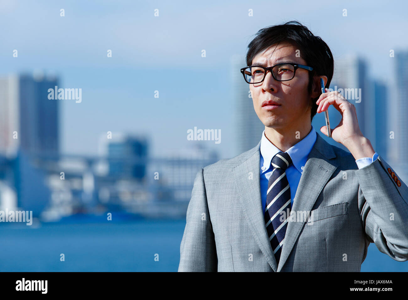 Japanese businessman on the phone downtown Tokyo, Japan Stock Photo - Alamy