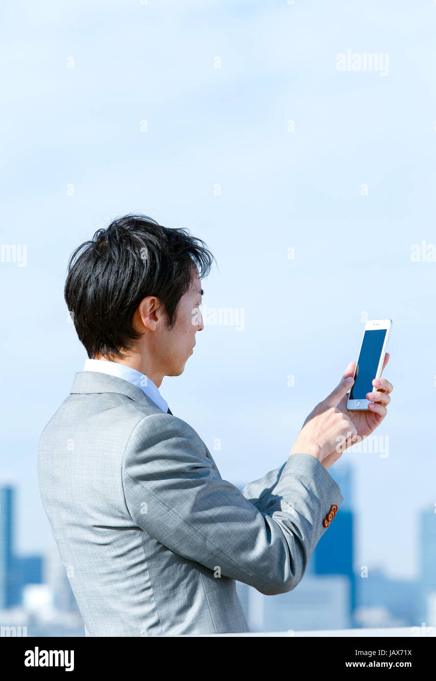 Japanese businessman with smartphone downtown Tokyo, Japan Stock Photo ...