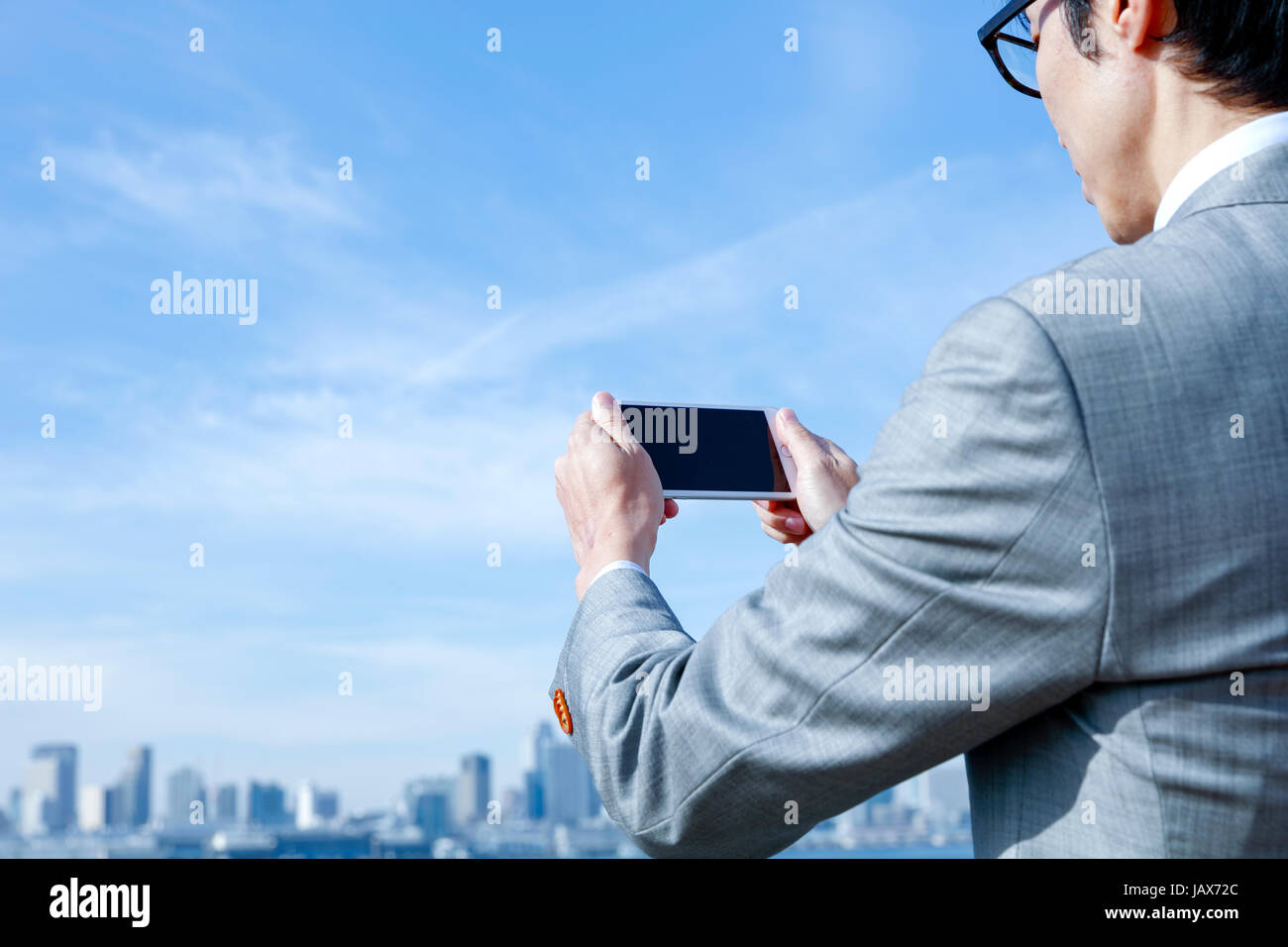Japanese businessman with smartphone downtown Tokyo, Japan Stock Photo ...