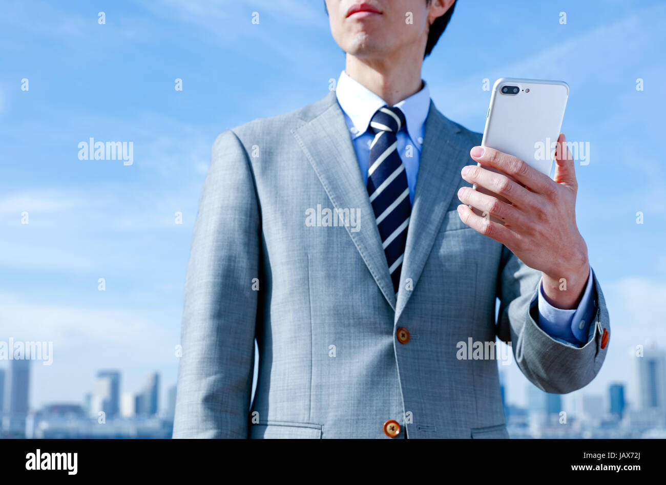 Japanese businessman with smartphone downtown Tokyo, Japan Stock Photo ...