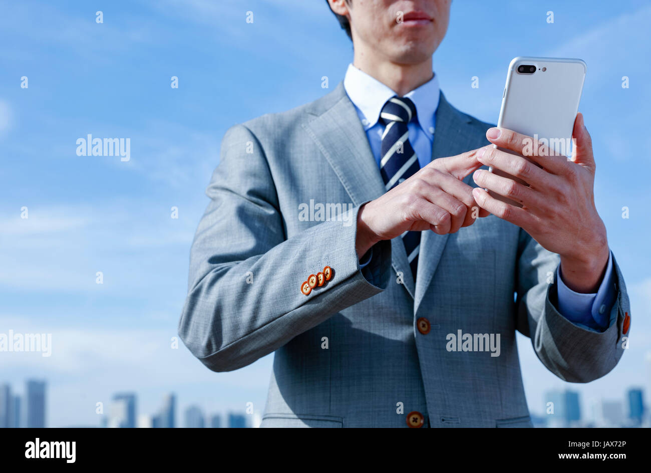 Japanese businessman with smartphone downtown Tokyo, Japan Stock Photo ...