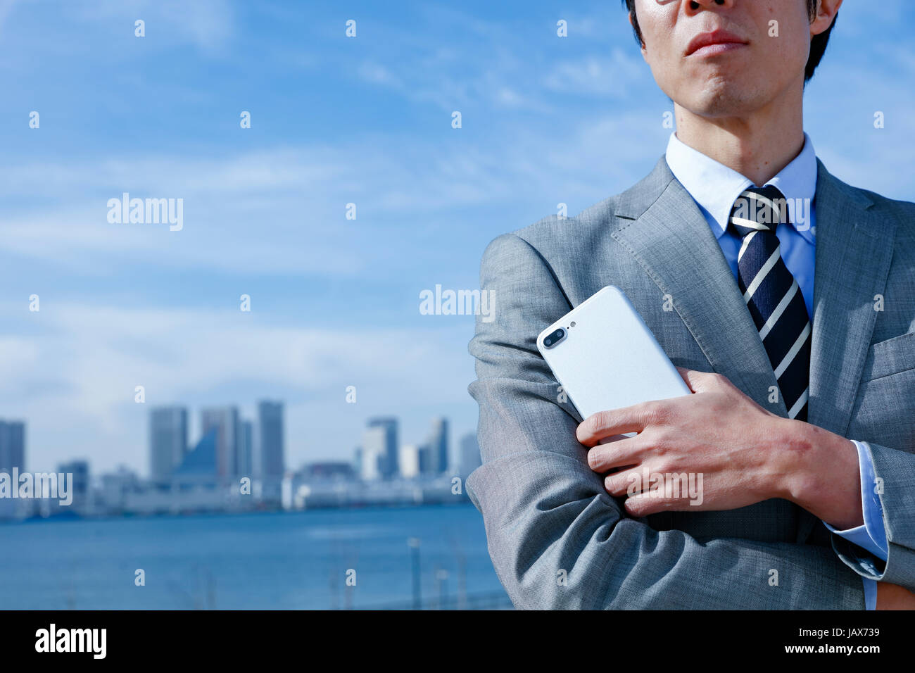 Japanese businessman with smartphone downtown Tokyo, Japan Stock Photo ...