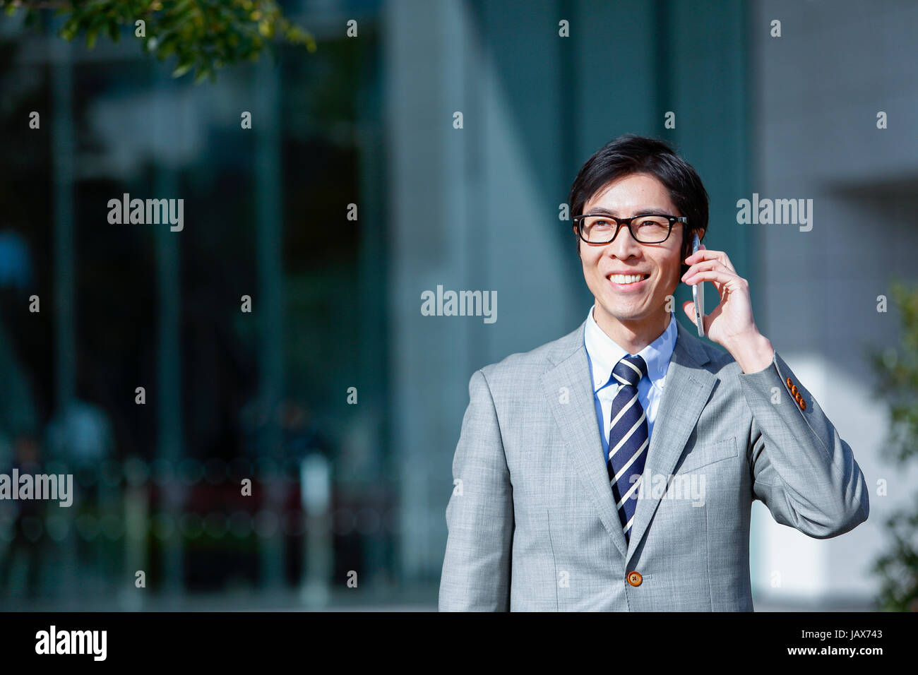 Japanese businessman on the phone downtown Tokyo, Japan Stock Photo - Alamy