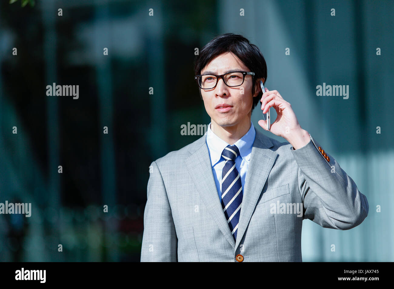 Japanese businessman on the phone downtown Tokyo, Japan Stock Photo - Alamy