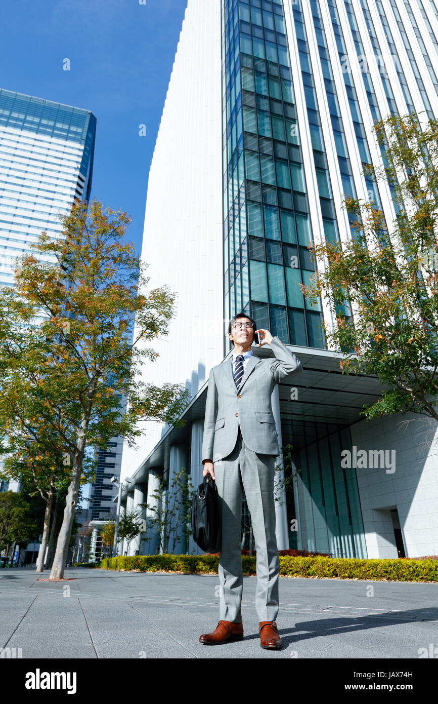 Japanese businessman on the phone downtown Tokyo, Japan Stock Photo - Alamy