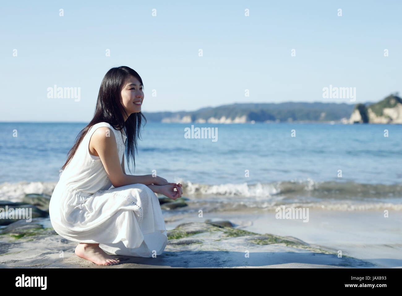 Crouching beach hi-res stock photography and images - Alamy