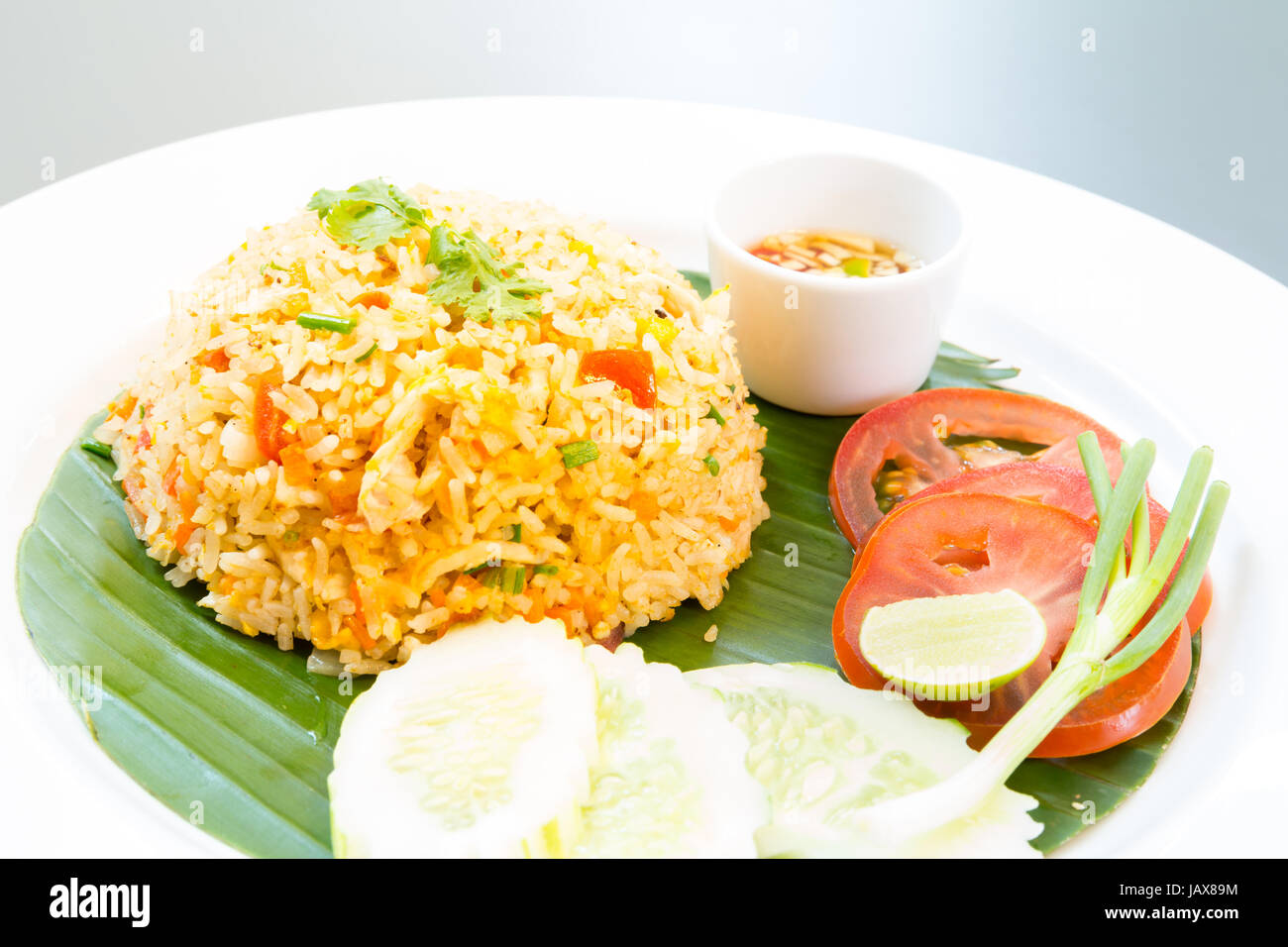 Chicken fried rice with tomato and cucumber Stock Photo - Alamy