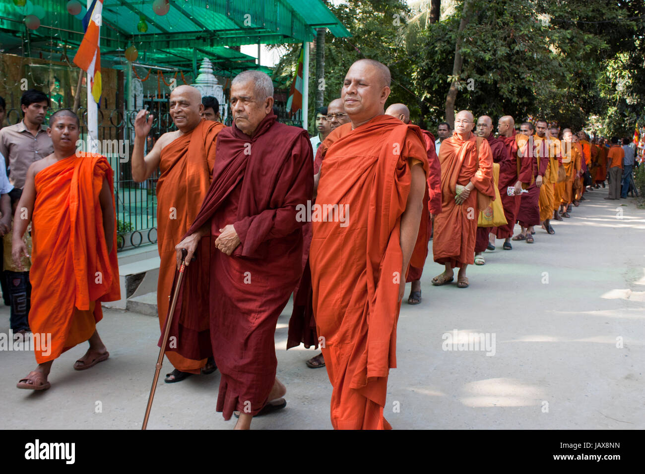 Hundreds of Buddhist monks walk in a line at the Dhammarajika Bouddha ...