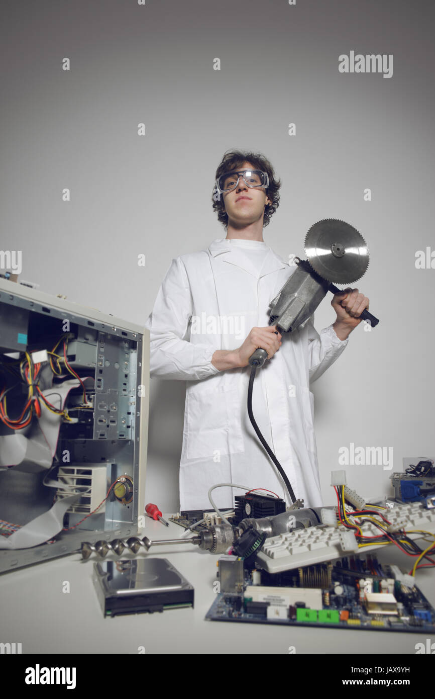 Bizarre computer technician with a circular saw Stock Photo - Alamy