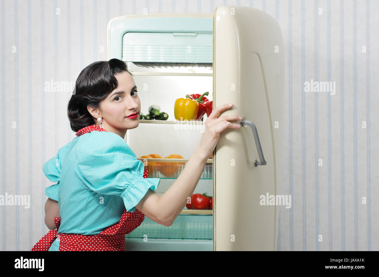 Beautiful woman posing with an open refrigerator Stock Photo - Alamy