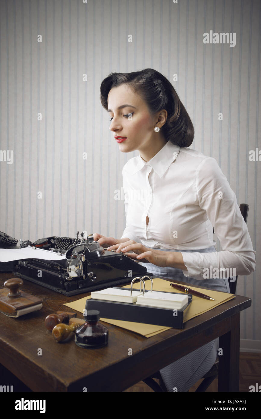 Retro business woman typing in her office Stock Photo - Alamy