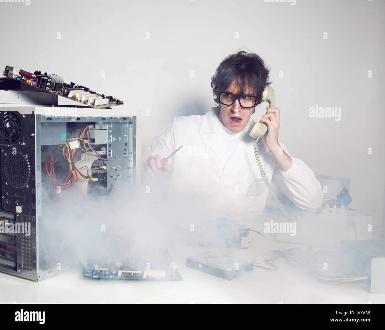 Computer technician in his laboratory is talking on the phone Stock ...