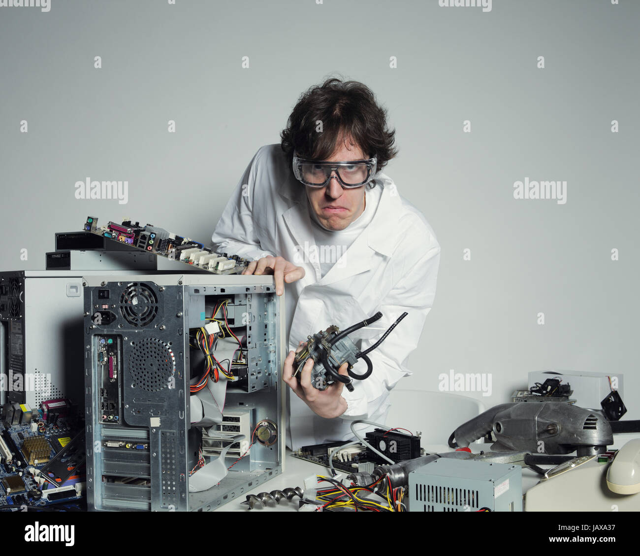 Portrait of a Computer technician with a computer destroyed Stock Photo ...