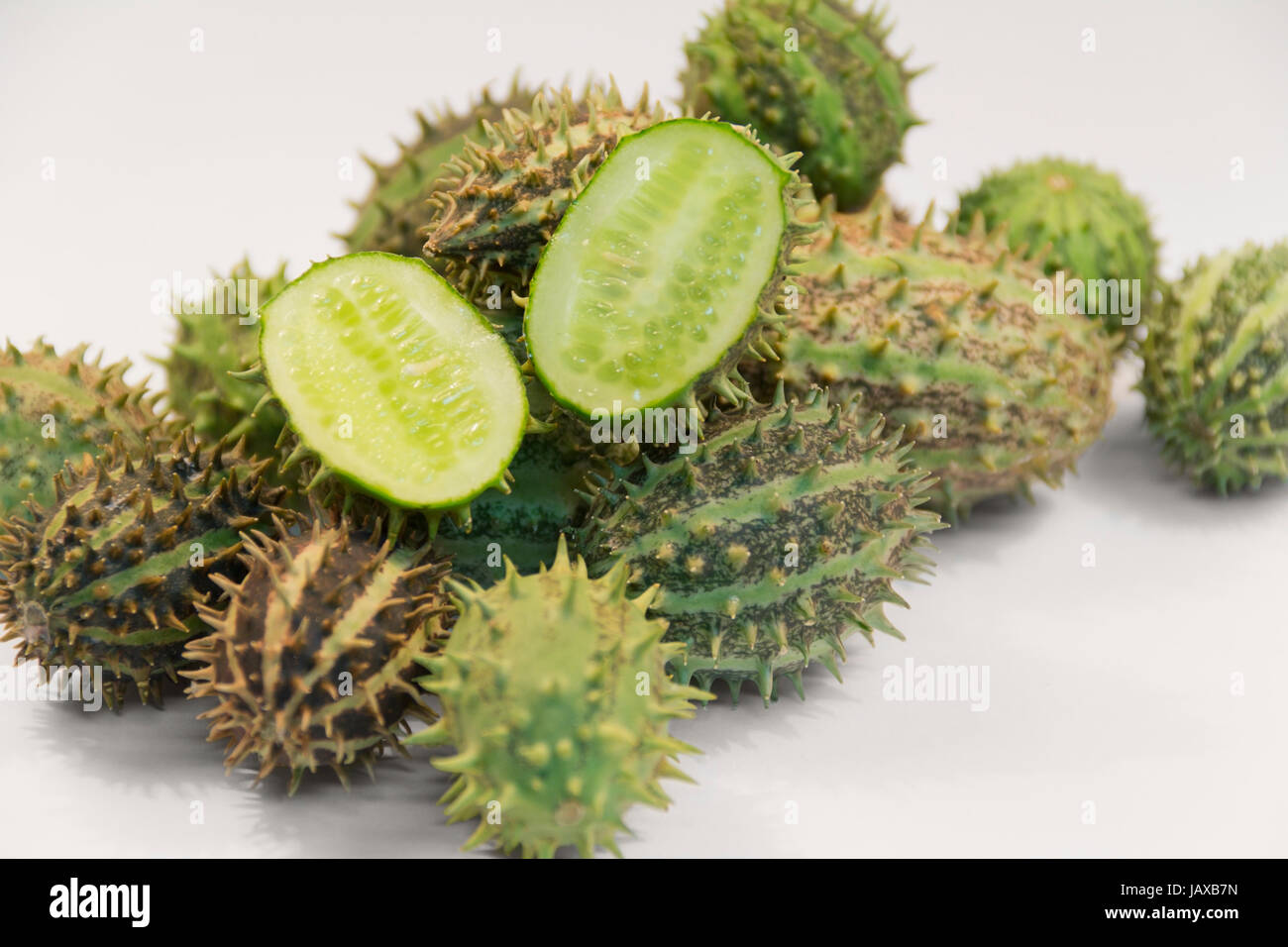 a pile of wild cucumber fruits in light back, one halved Stock Photo ...