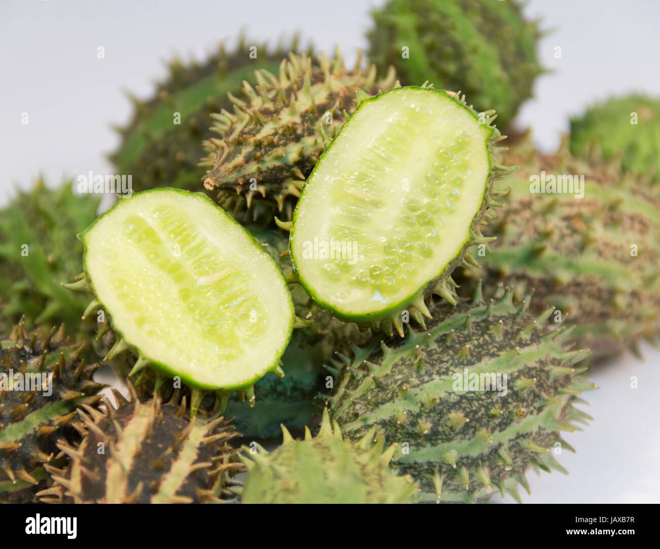 a pile of wild cucumber fruits in light back, one halved Stock Photo ...