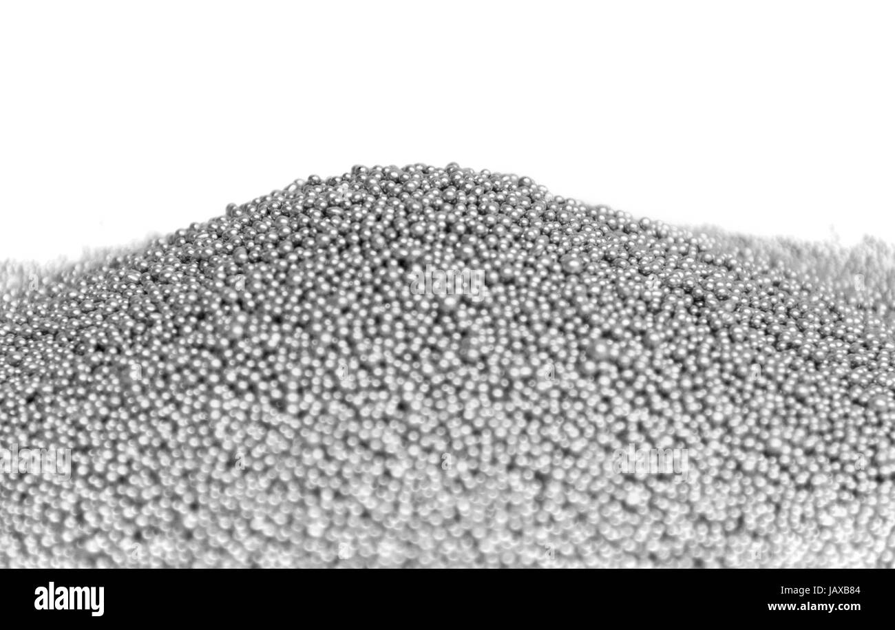 pile of silver metallic beadlets in white back Stock Photo - Alamy