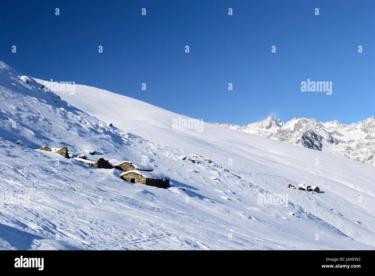 Winter landscape in the italian Alps with abandoned pasture huts ...