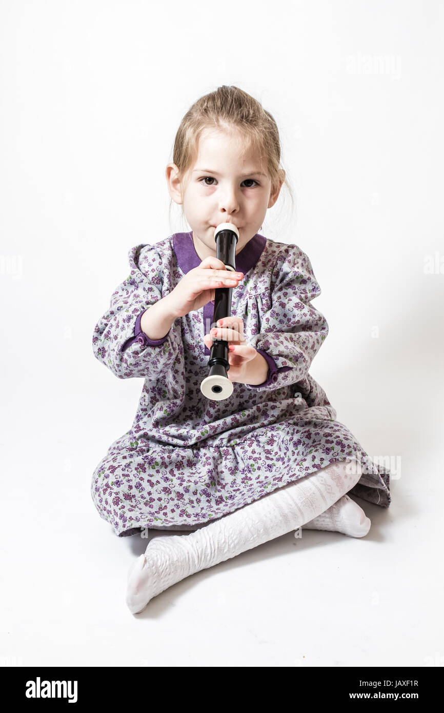Little cute girl playing the flute on a white background Stock Photo ...