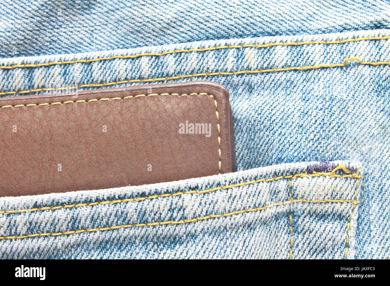 Brown wallet in jeans trousers back pocket, close up texture Stock ...