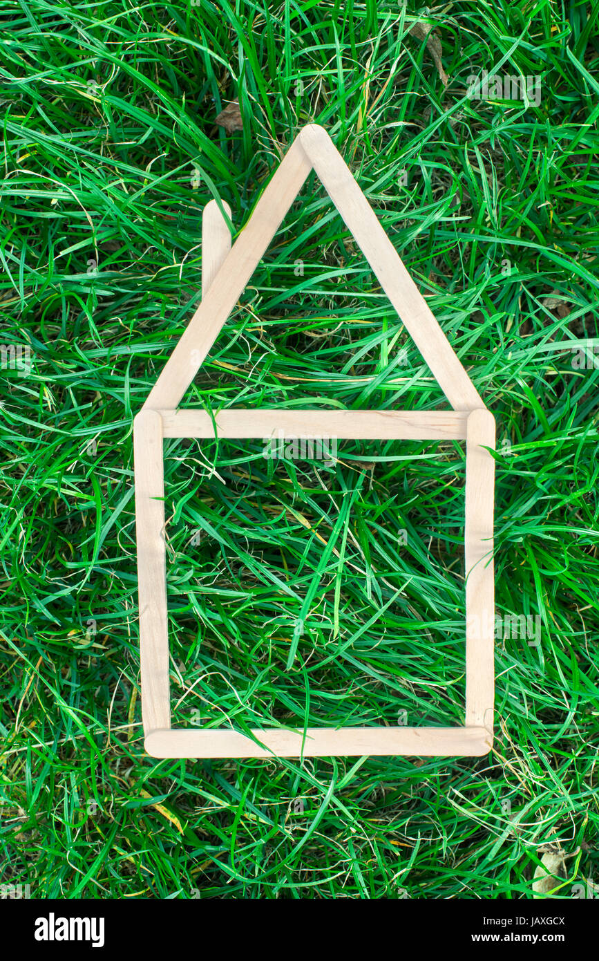Model house made of wooden sticks on green grass Stock Photo - Alamy