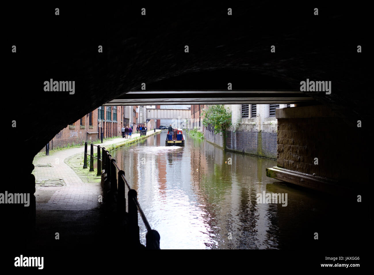 Barge on Manchester Canal seen through road bridge, city centre ...